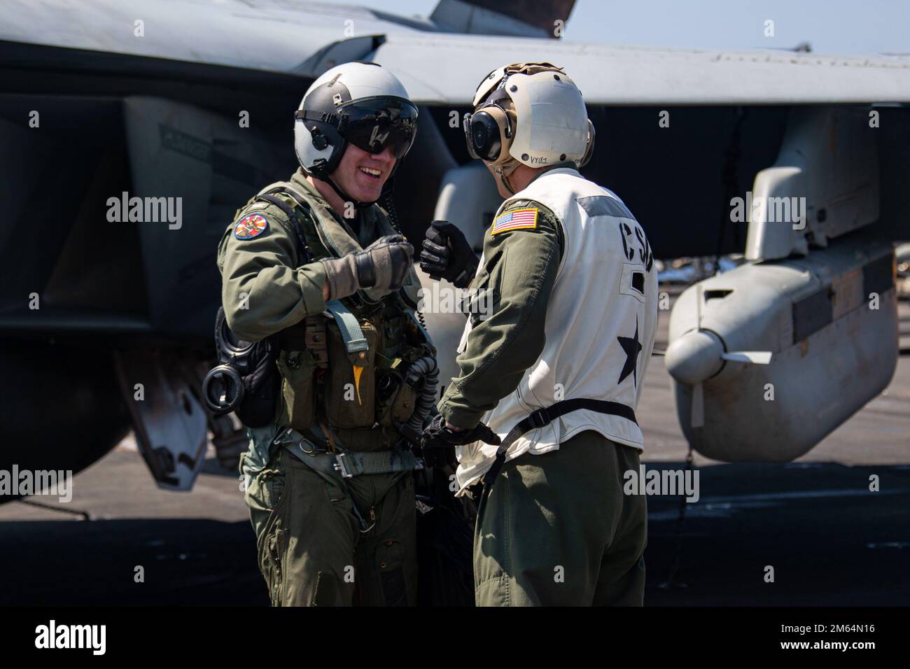 SOUTH CHINA SEA (April 1, 2022) Rear Admiral J.T. Anderson, right, commander, Carrier Strike ...