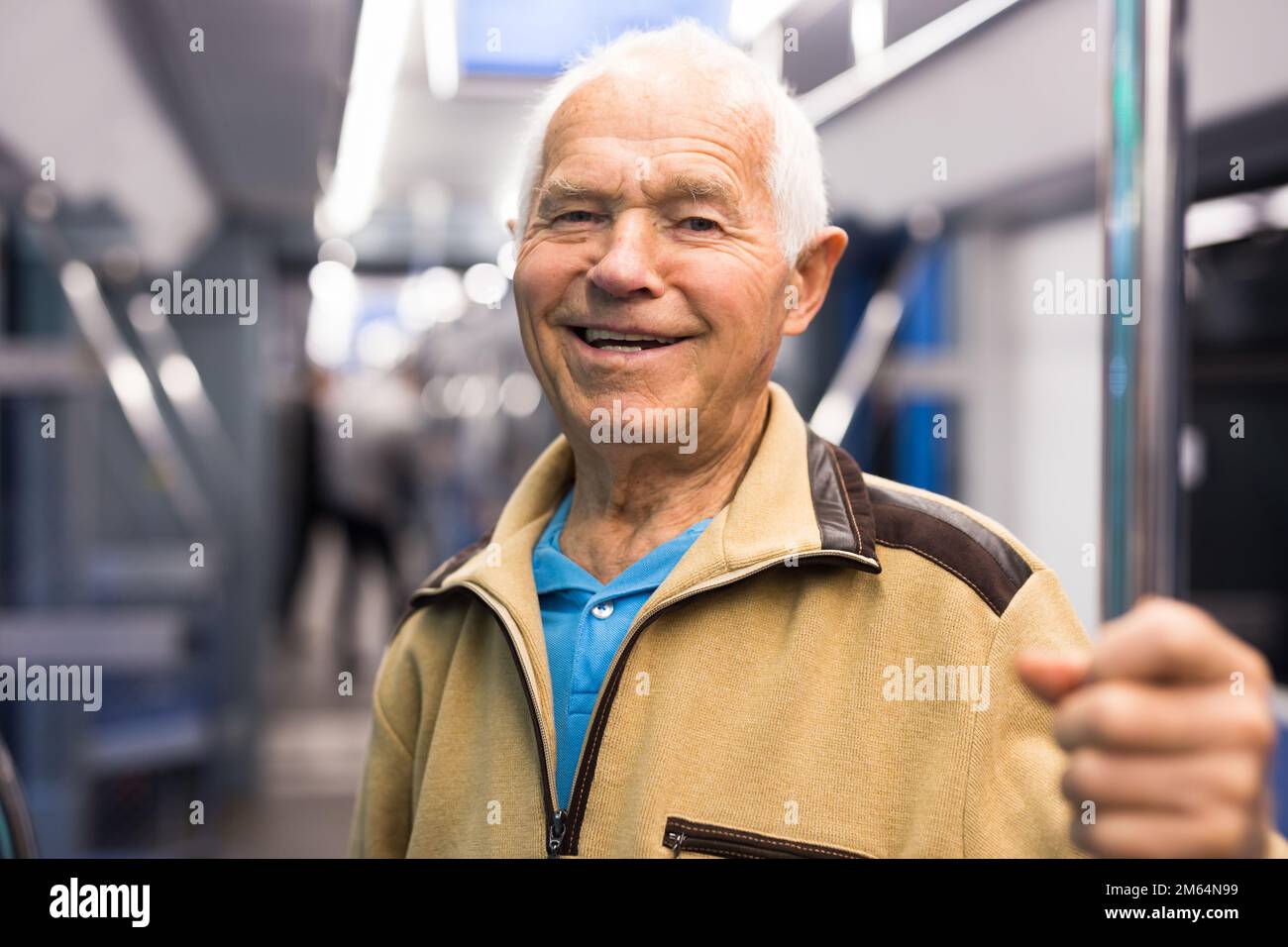 Old man standing in subway car Stock Photo - Alamy