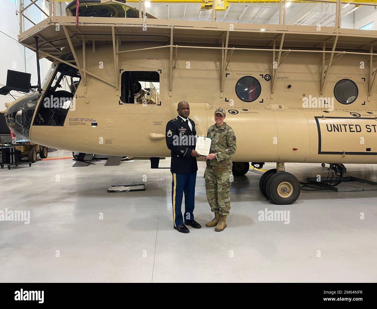 Staff Sgt. Marcus Farmer receives his certificate of promotion from ...