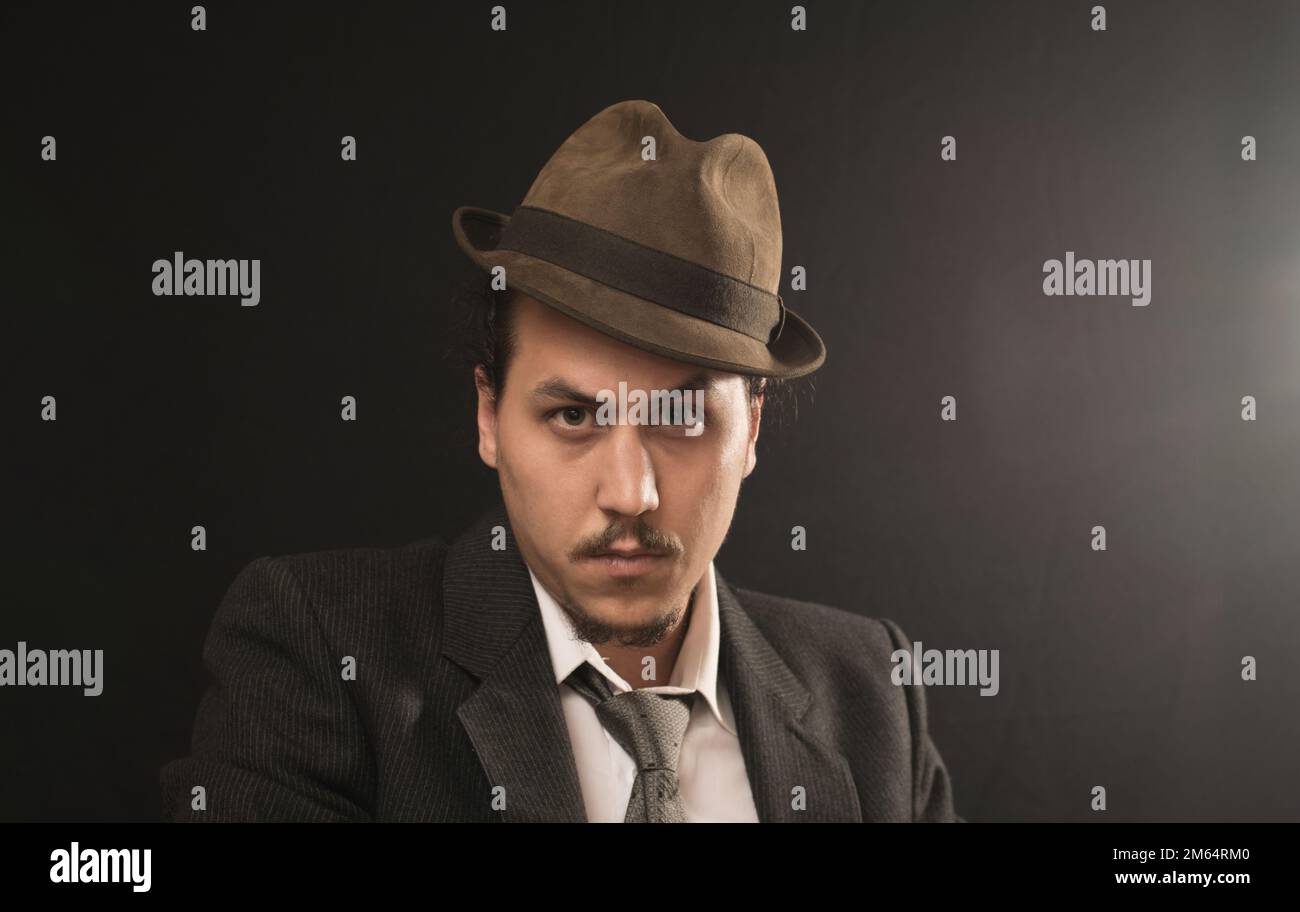 Old school mobster in a retro hat Stock Photo - Alamy