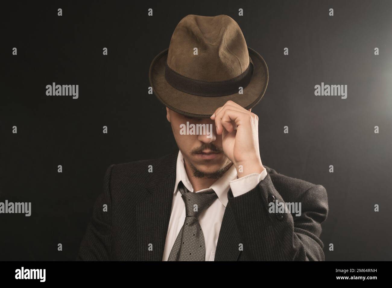 Old school mobster in a retro hat Stock Photo - Alamy