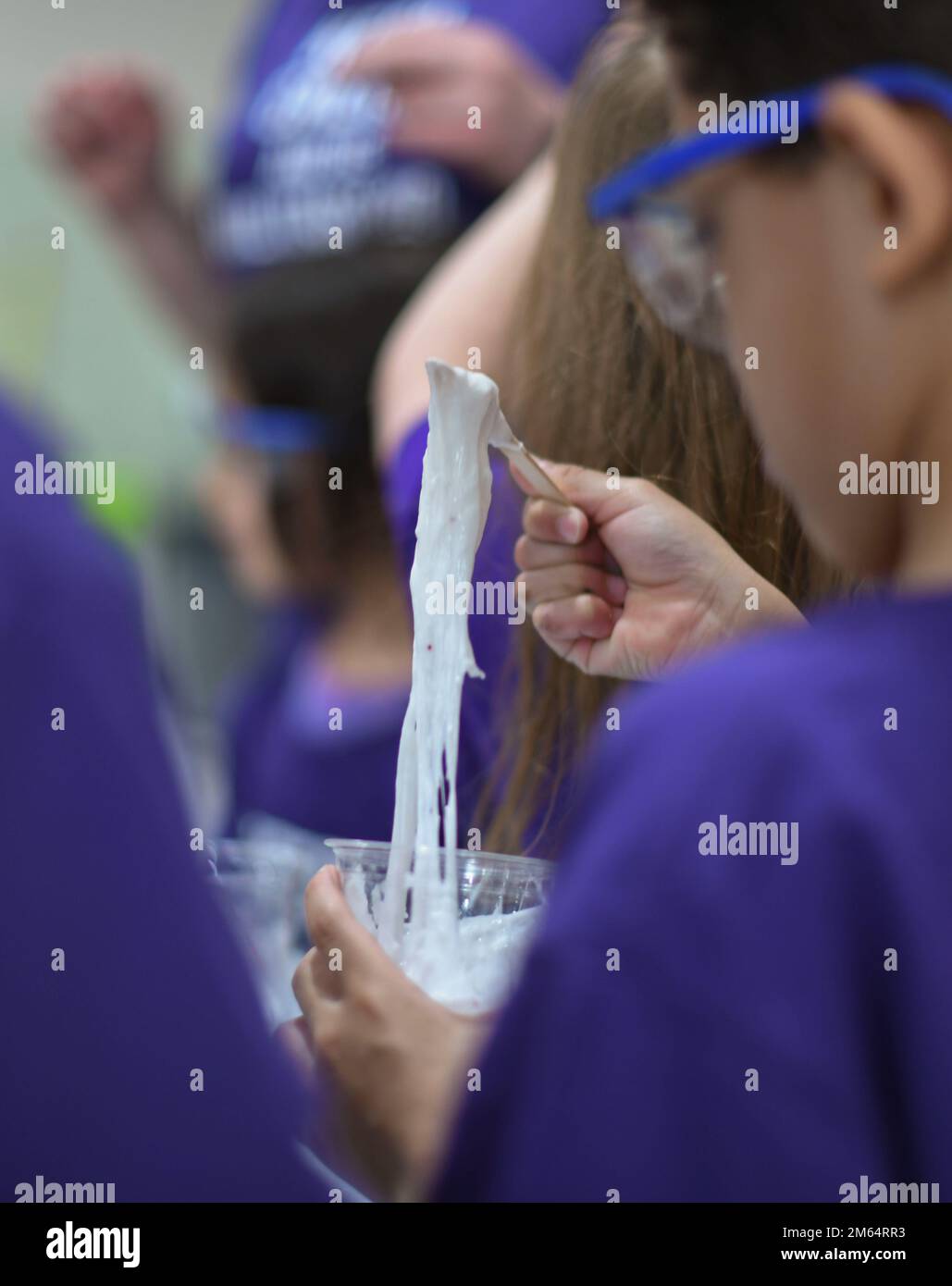 A student plays with slime he made for a project during STEM Day at ...