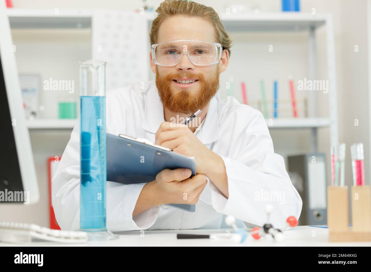 man taking notes about experiment Stock Photo - Alamy
