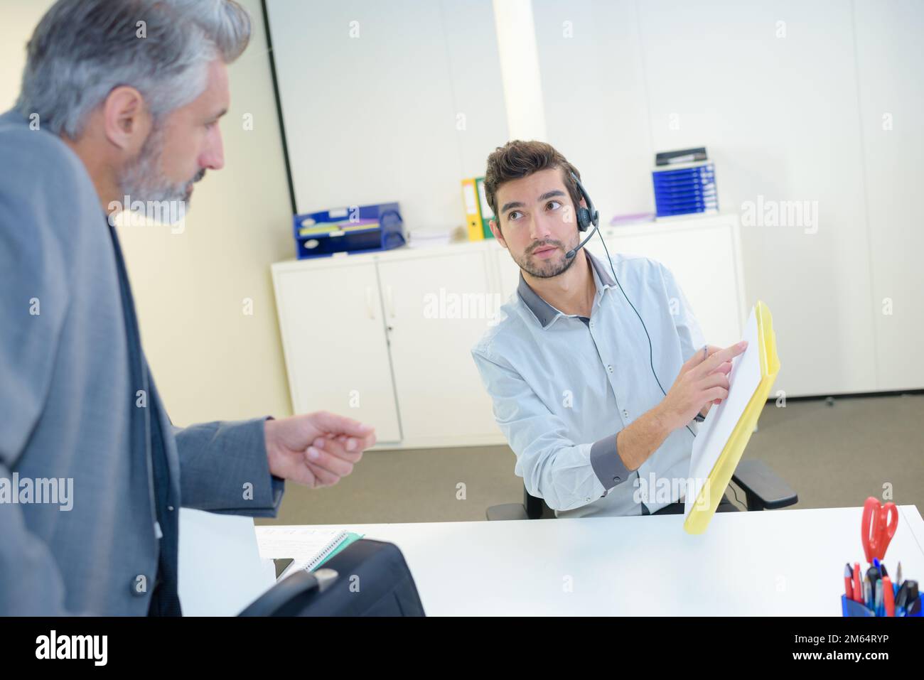 young man near reception desk in hotel Stock Photo - Alamy