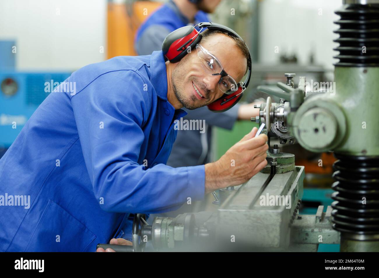 modern industrial machine operator posing smiling Stock Photo - Alamy