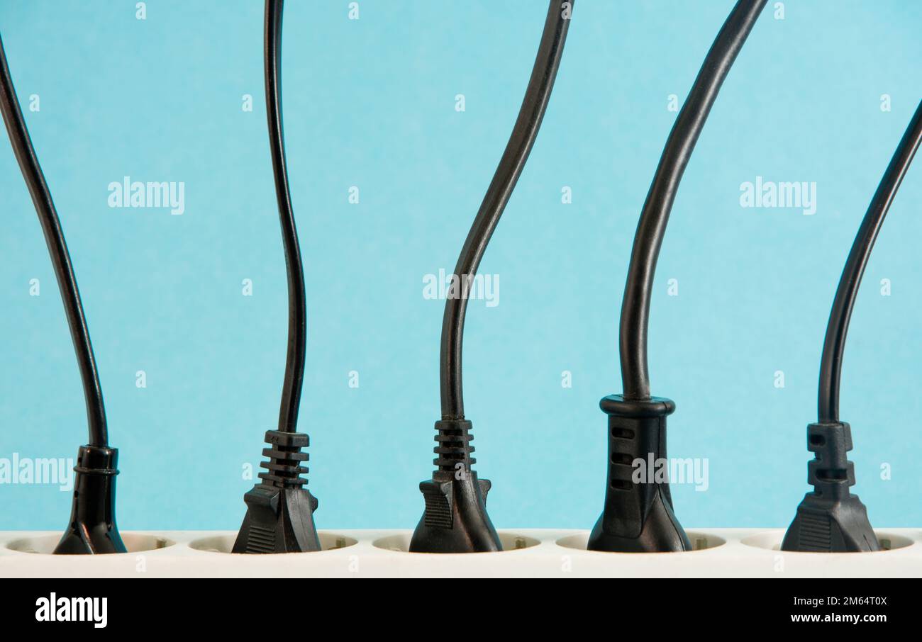 White extension cord with three plugs on blue background Stock Photo ...