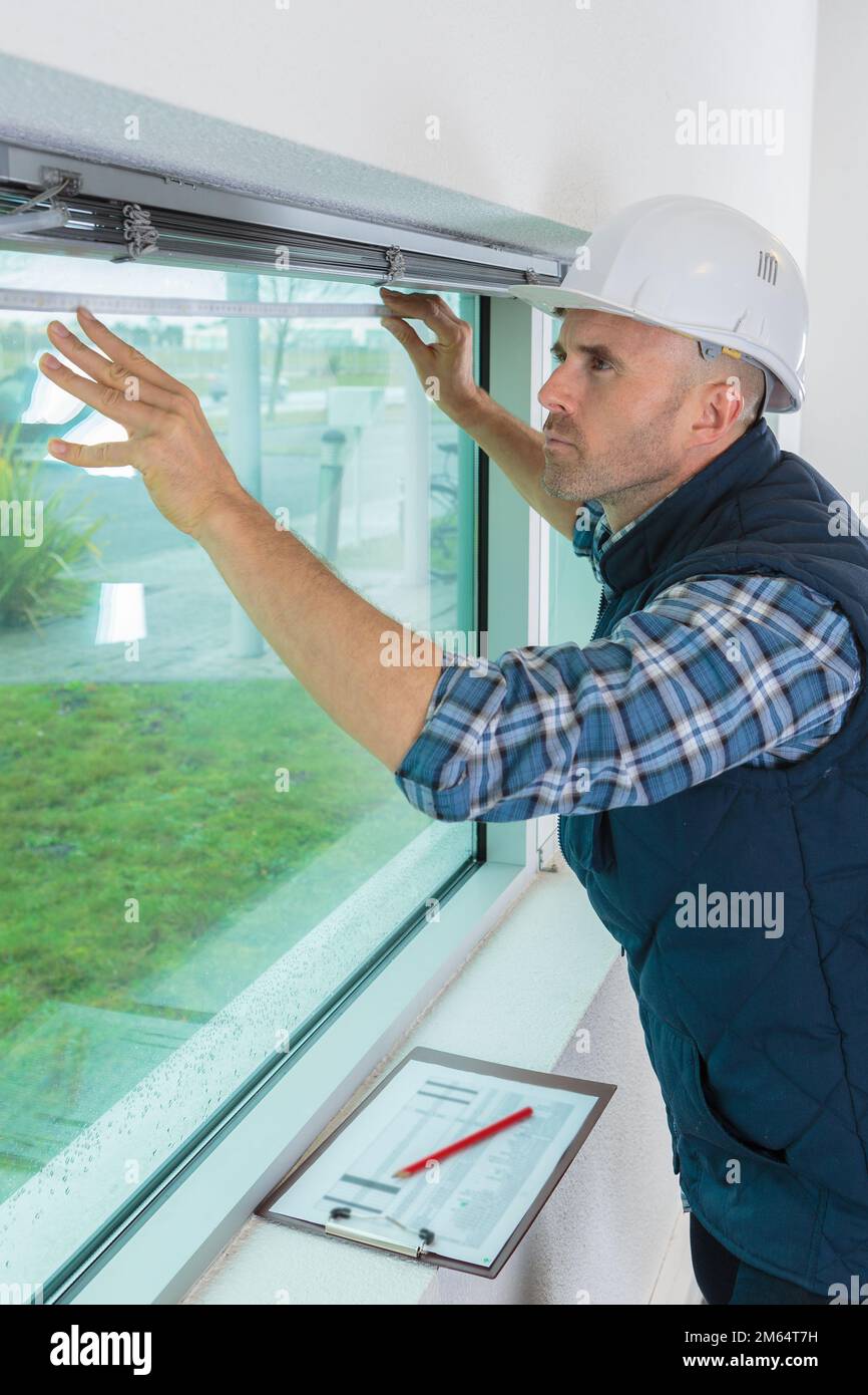 construction worker building new house and fitting window Stock Photo ...