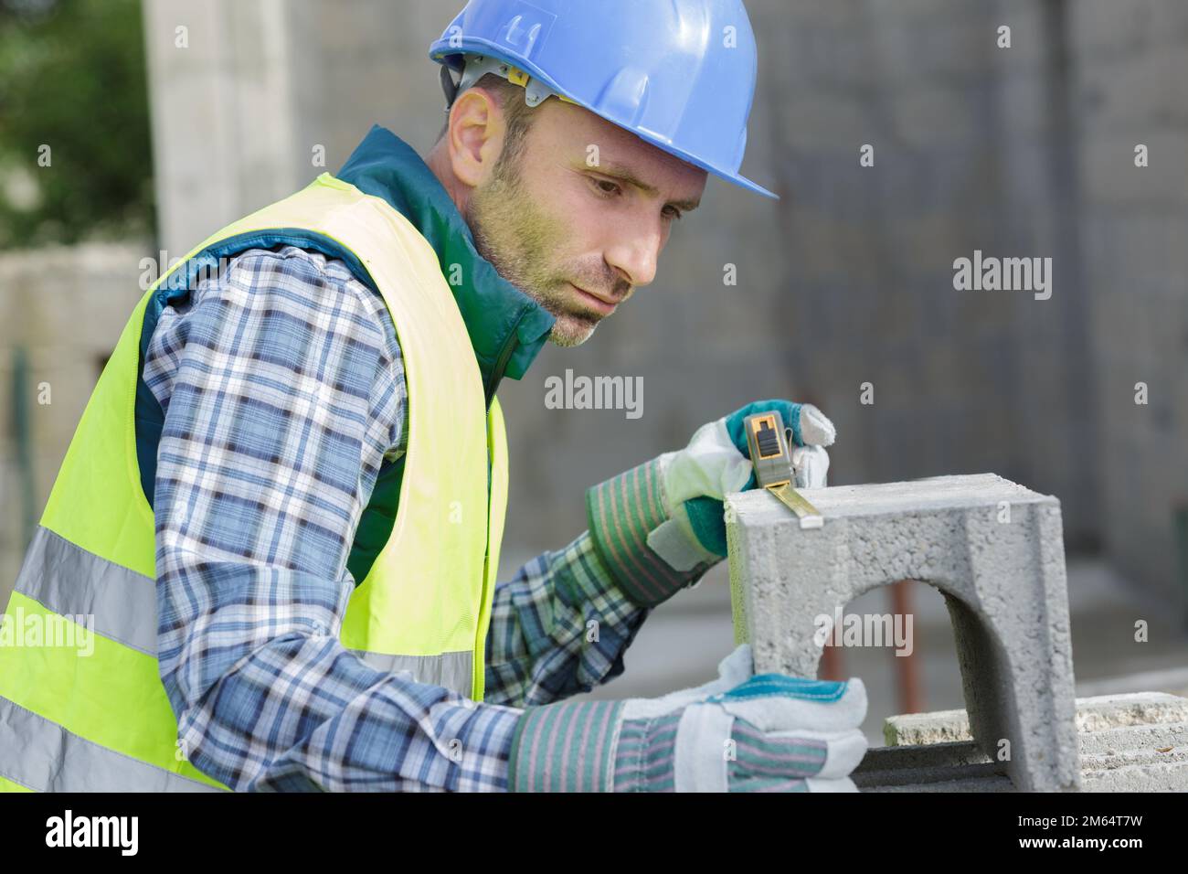 male builder working with cement block Stock Photo - Alamy