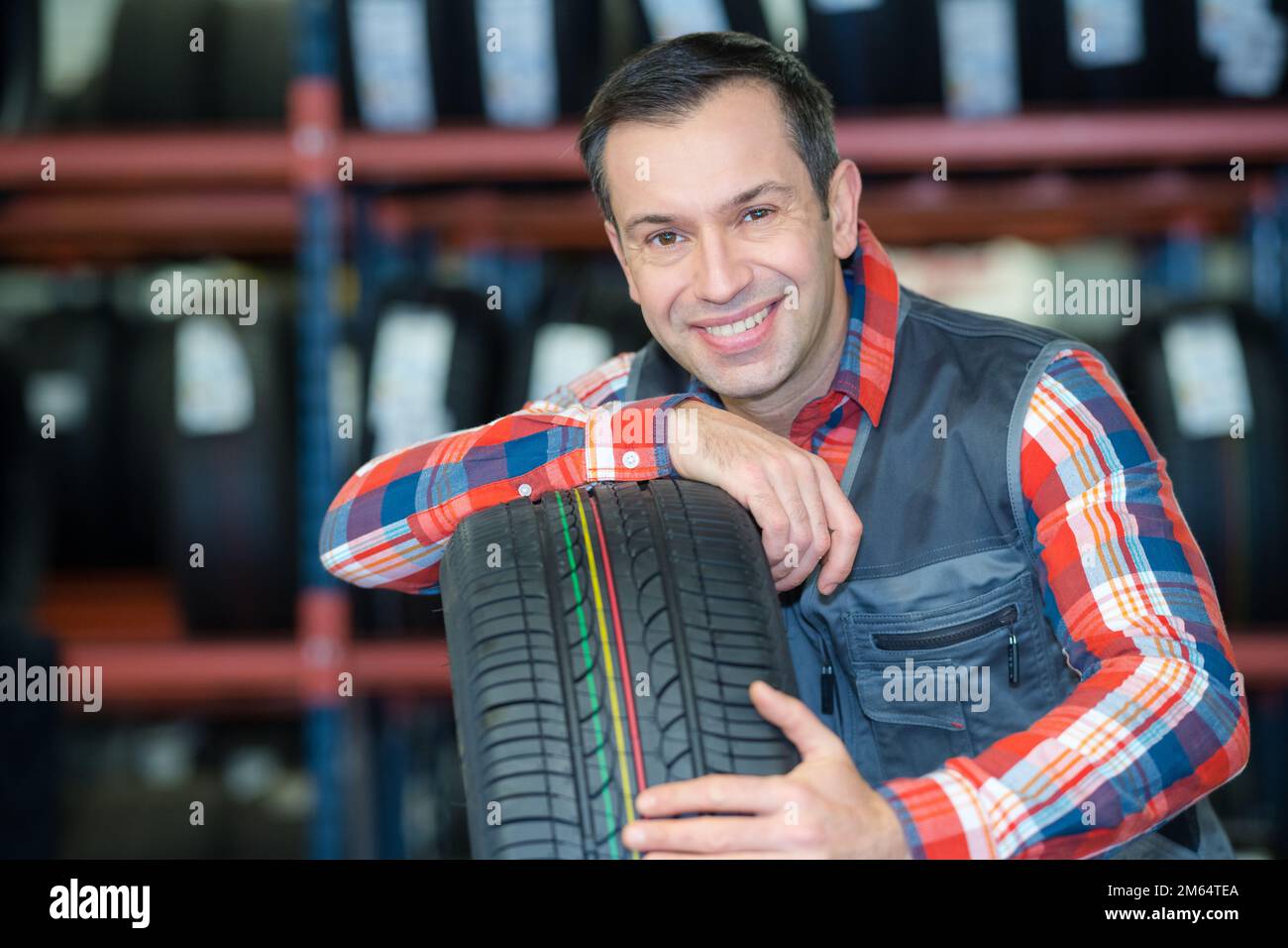 Man fitting new tyre hi-res stock photography and images - Alamy