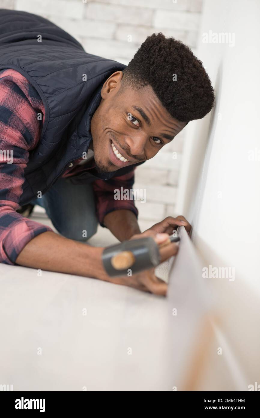 a young man holding hammer Stock Photo - Alamy