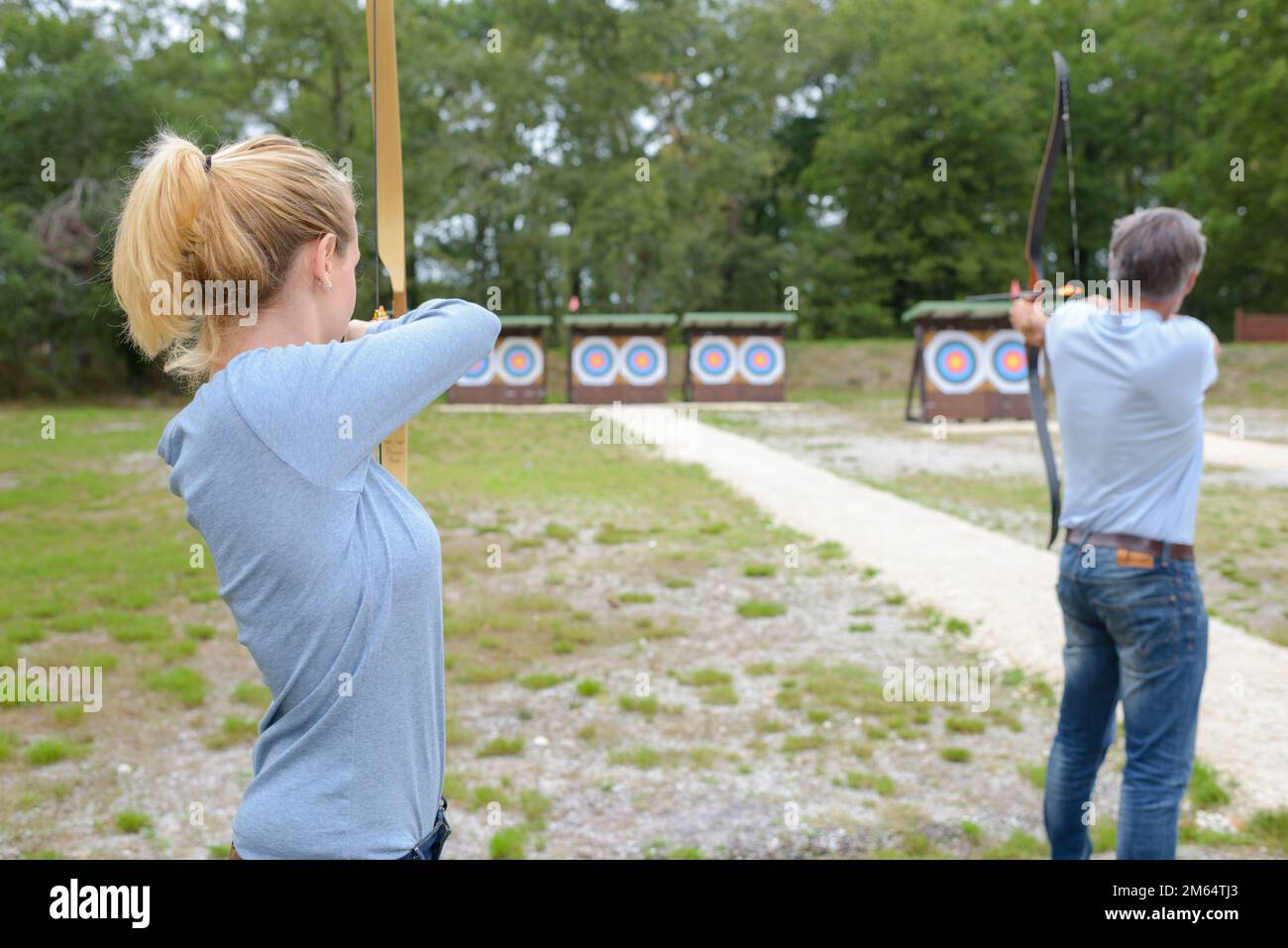 portrait of couple hitting the target Stock Photo - Alamy