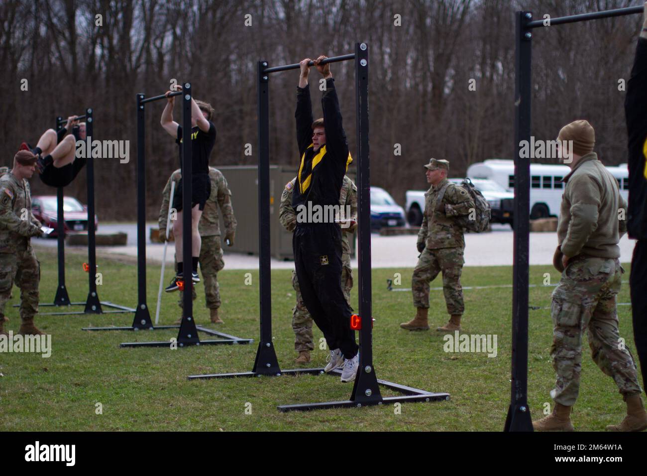Soldiers perform leg-tucks for the physical fitness event during the ...