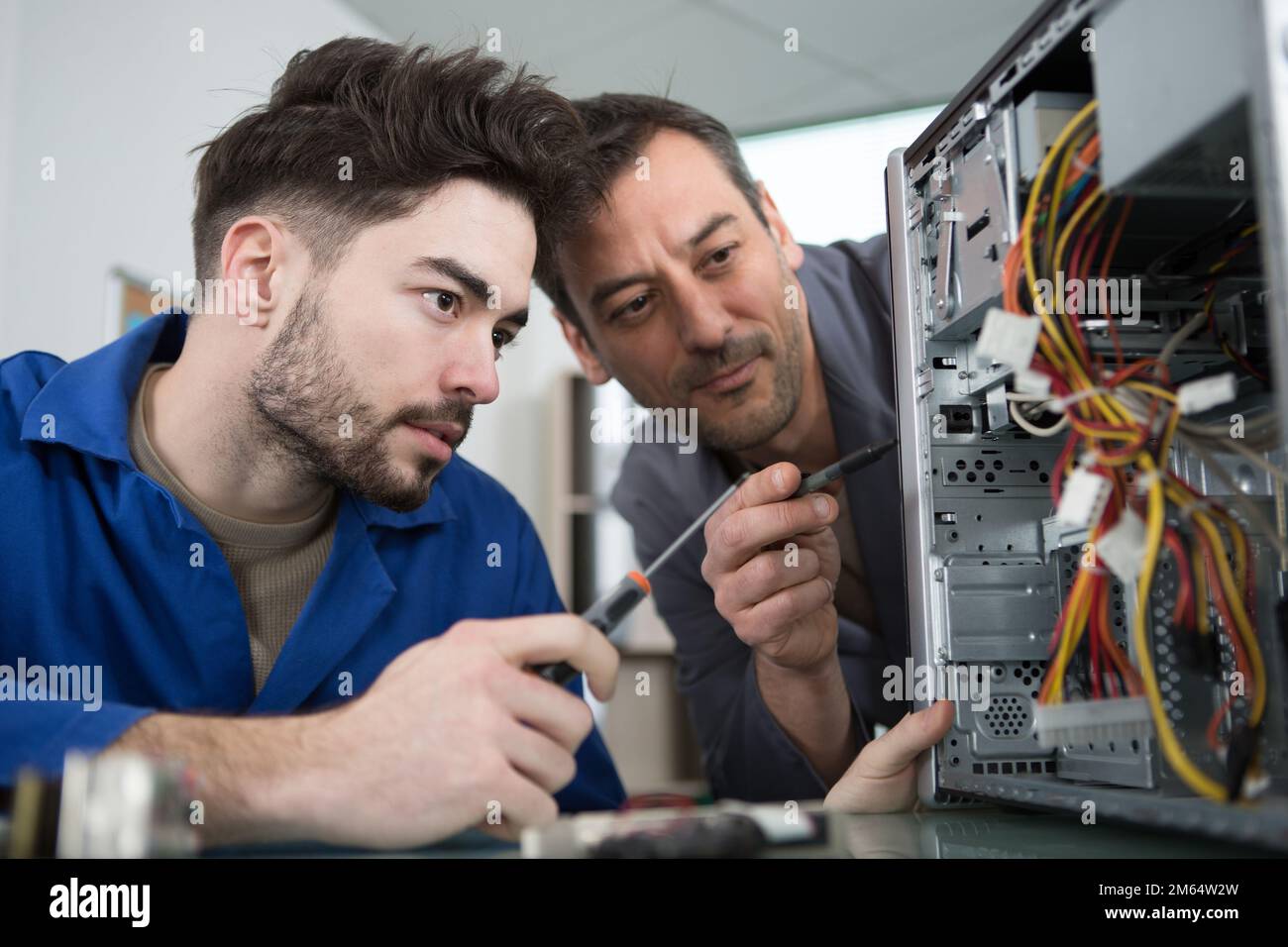 technician fitting component into computer Stock Photo - Alamy