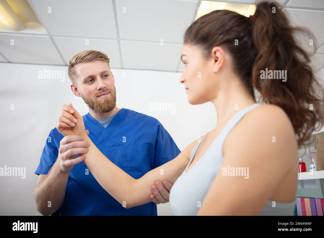 male physiotherapist giving massage to female patient Stock Photo - Alamy