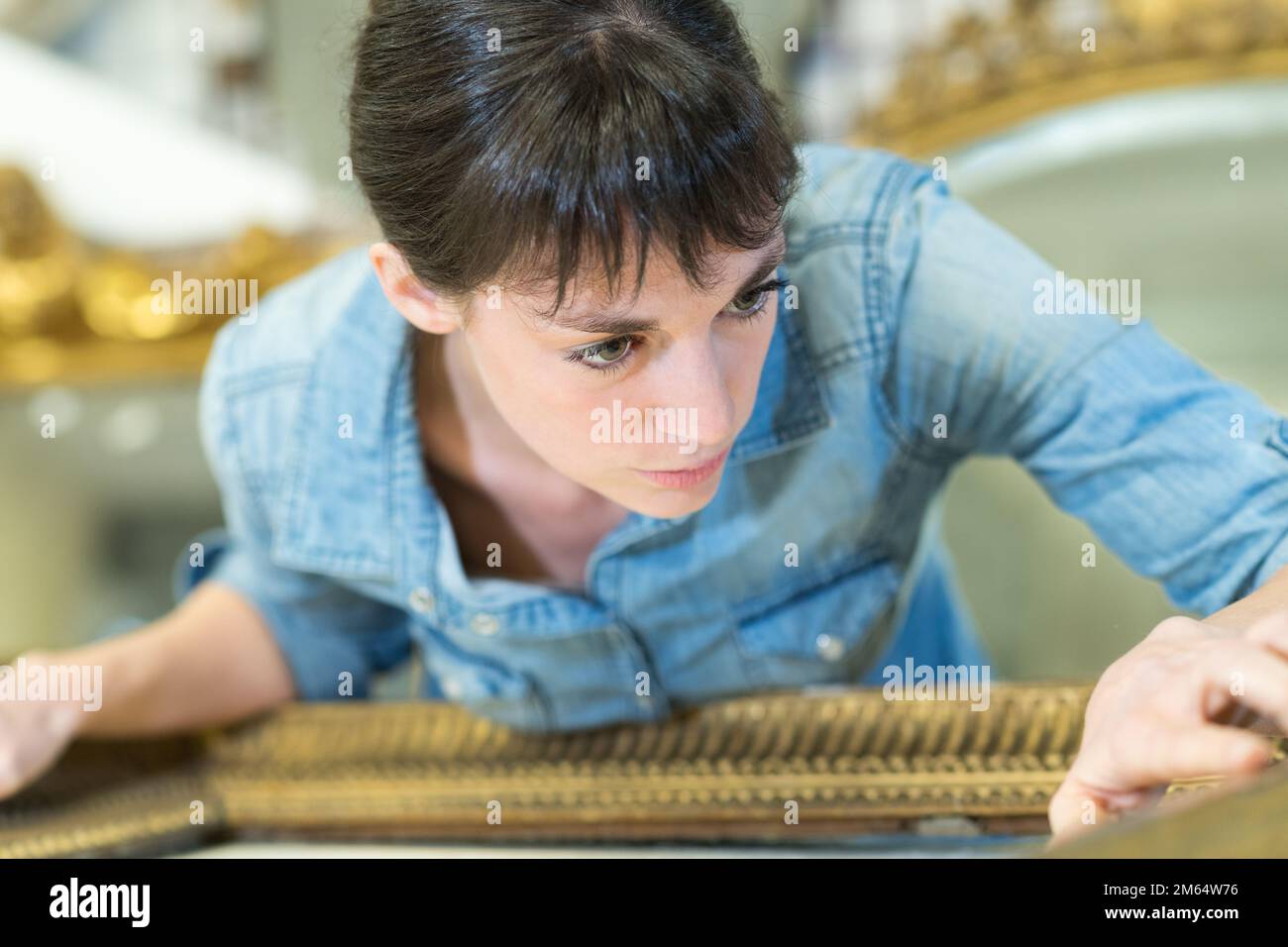 young female working in picture frame atelier Stock Photo - Alamy