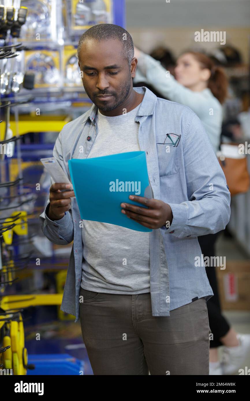 man in hardware store checking list Stock Photo - Alamy