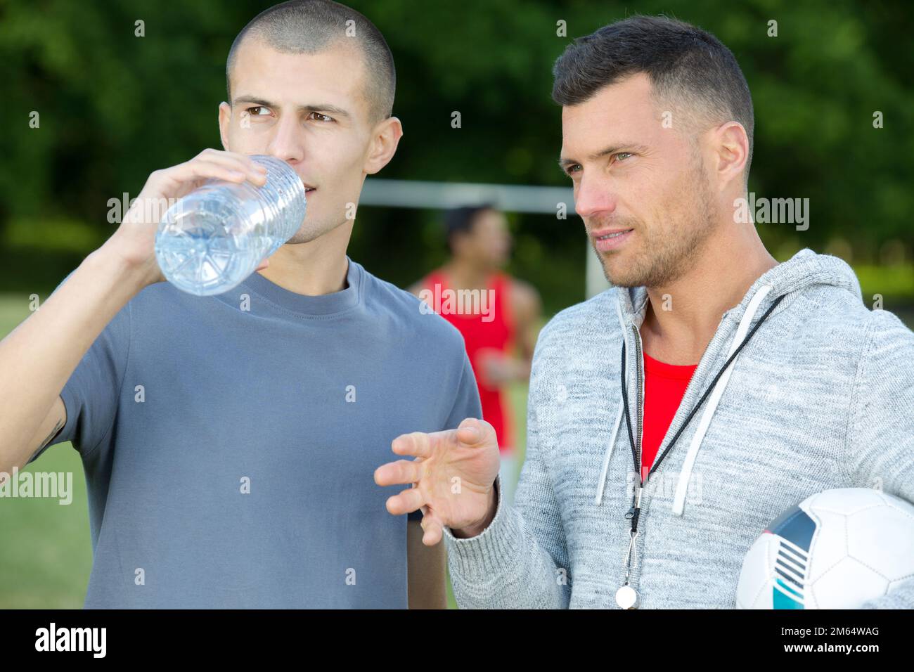 football player drinking water during breaks Stock Photo - Alamy