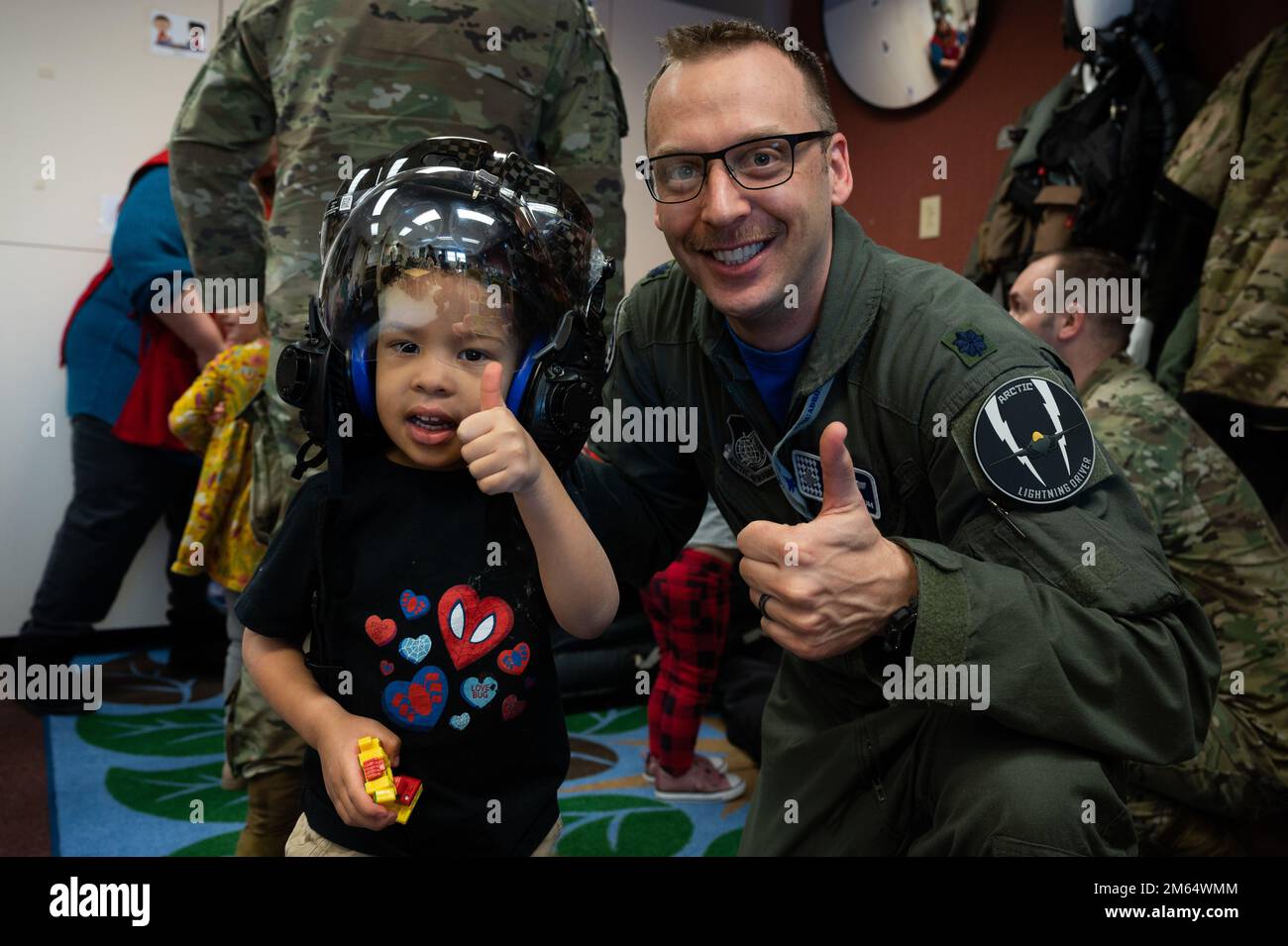 An Eielson Child Development Center student and U.S. Air Force Lt. Col. Grant Saum, the 354th ...