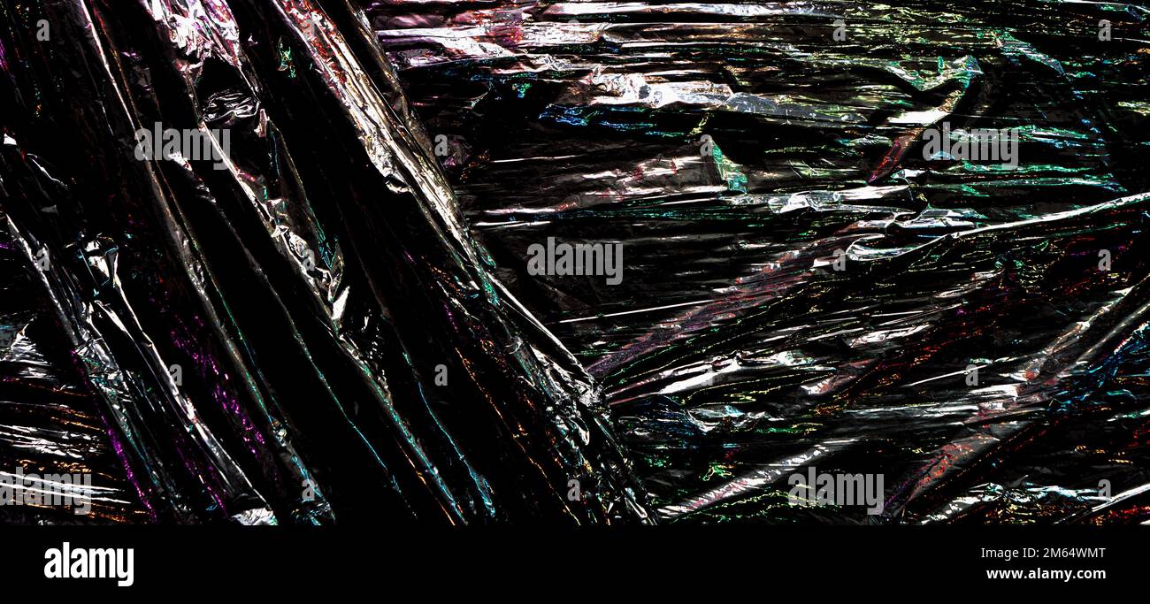 Black color plastic wrap background. Dark crumpled wrinkled plastic ...