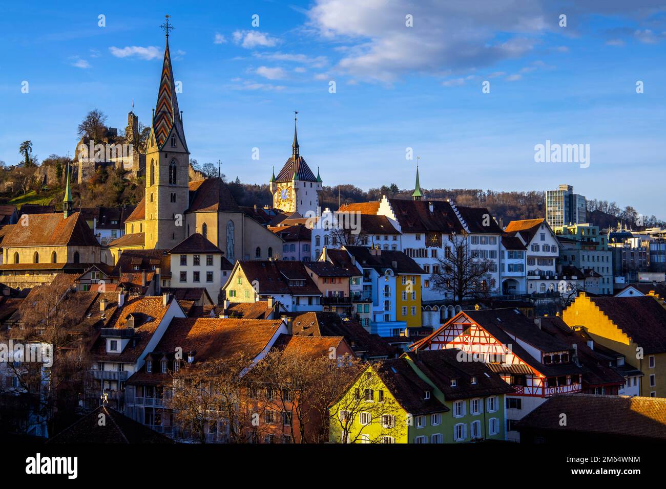 Baden old town at sunset and the covered wooden bridge over Limmat ...