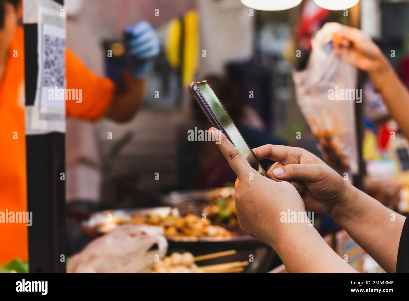 Woman use smartphone scan QR code in food store Stock Photo - Alamy