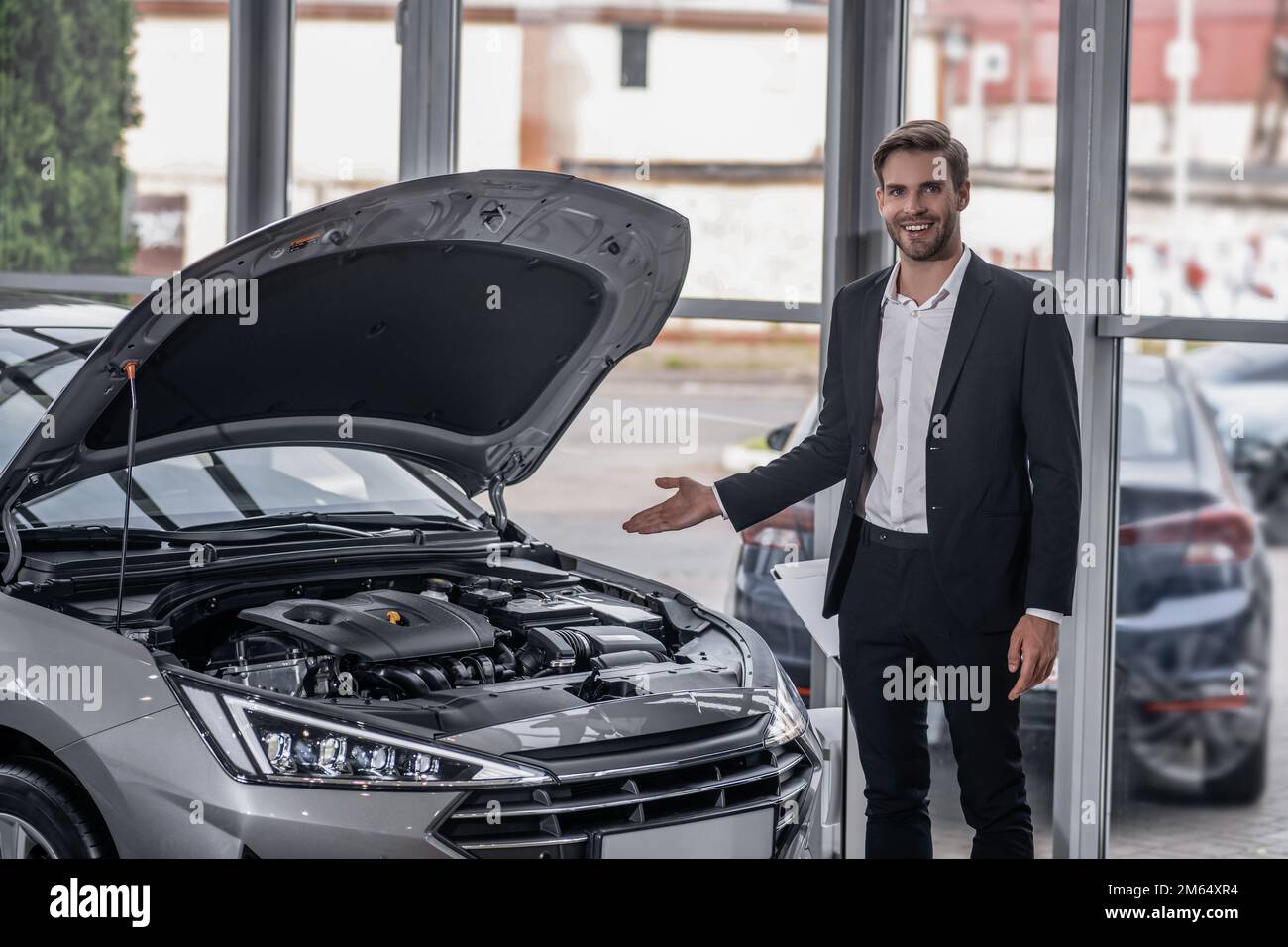 Male sales manager on a car salon Stock Photo - Alamy
