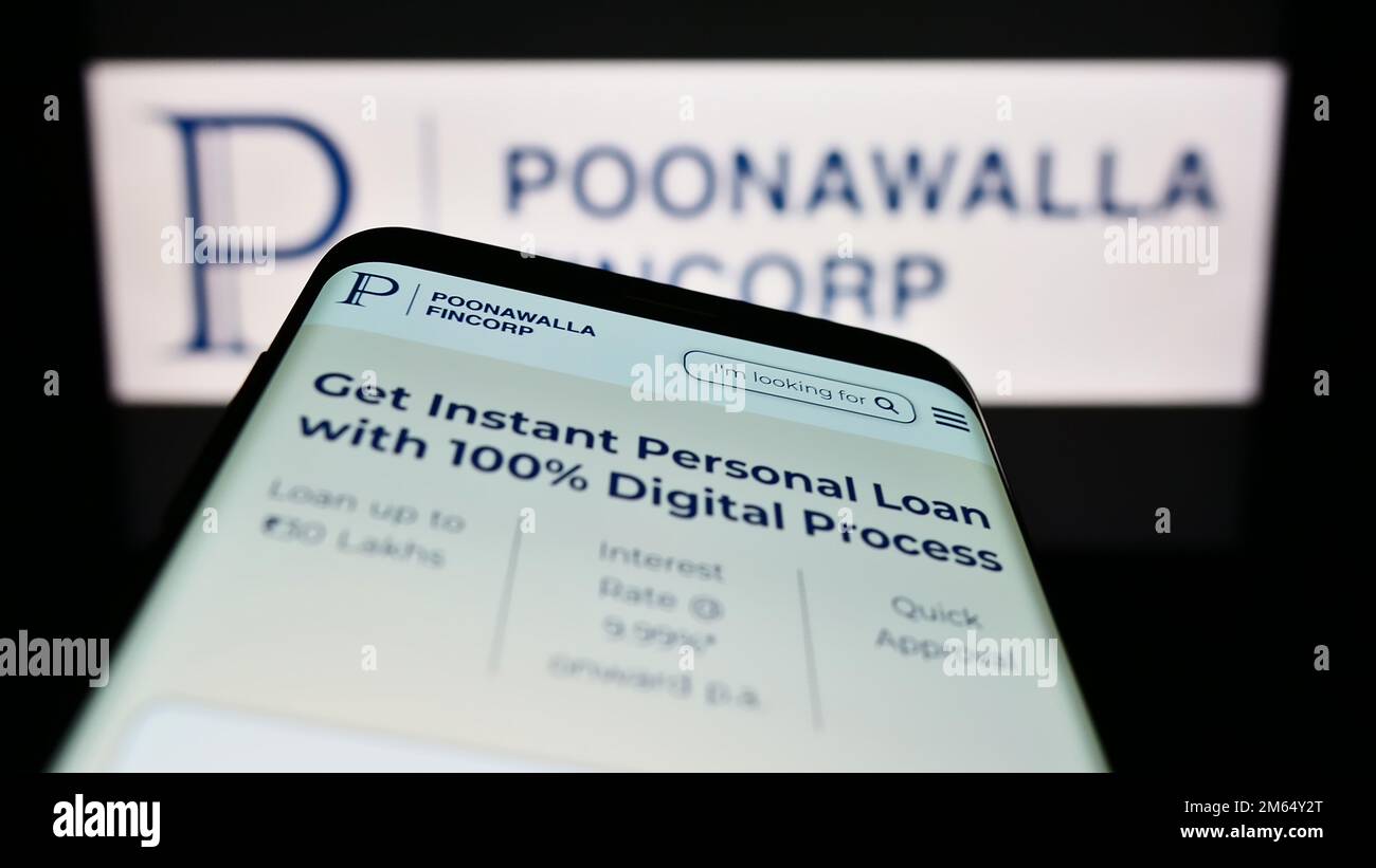 Mobile phone with website of financial company Poonawalla Fincorp ...