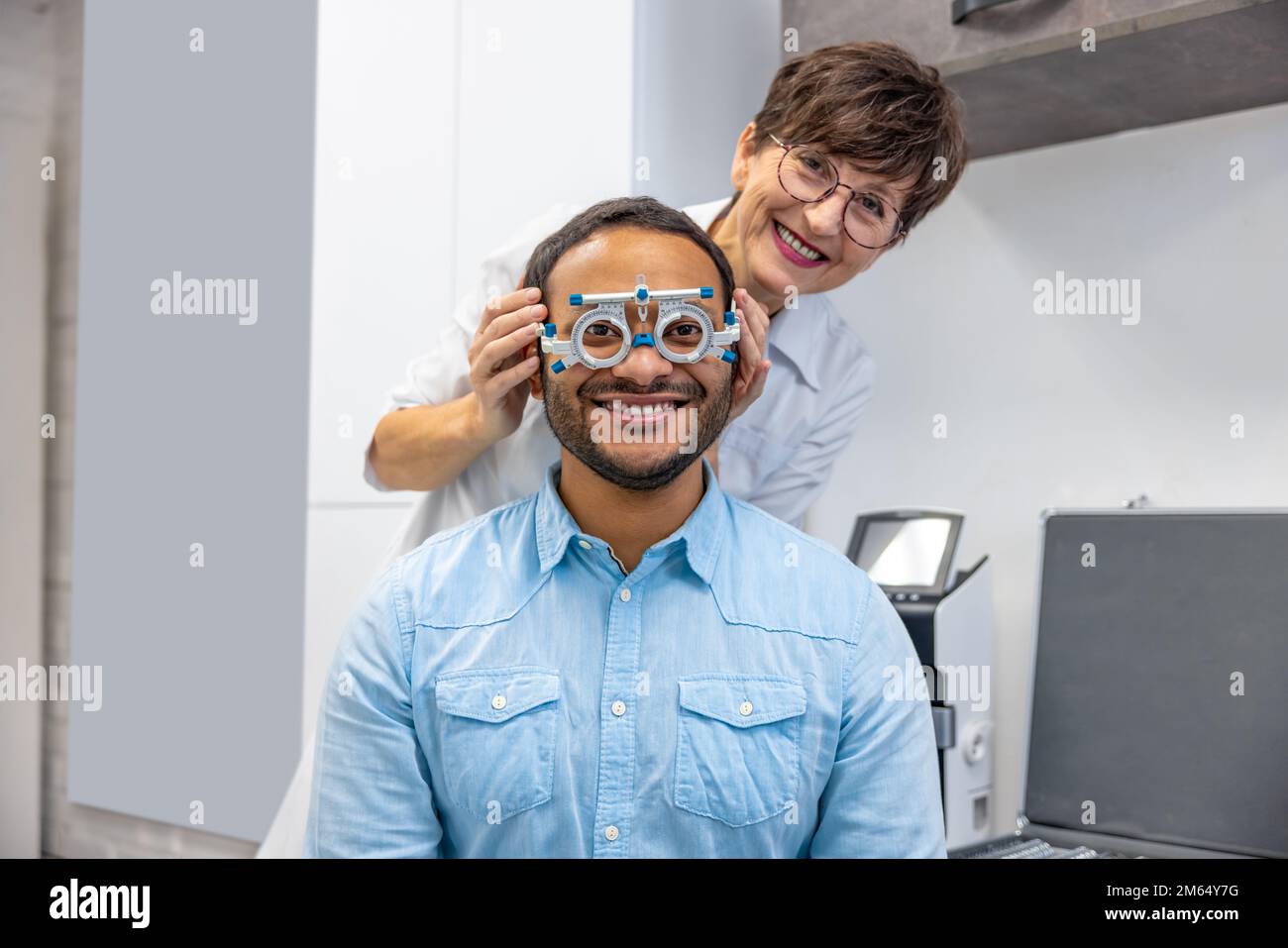 Female optometrist working with a male patient Stock Photo - Alamy