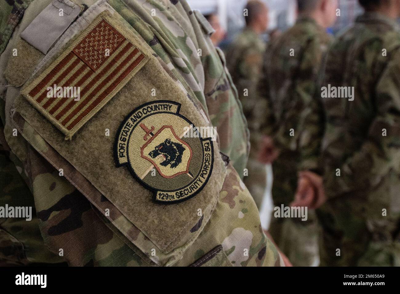 A 129th Security Forces Squadron defender stands in formation during ...