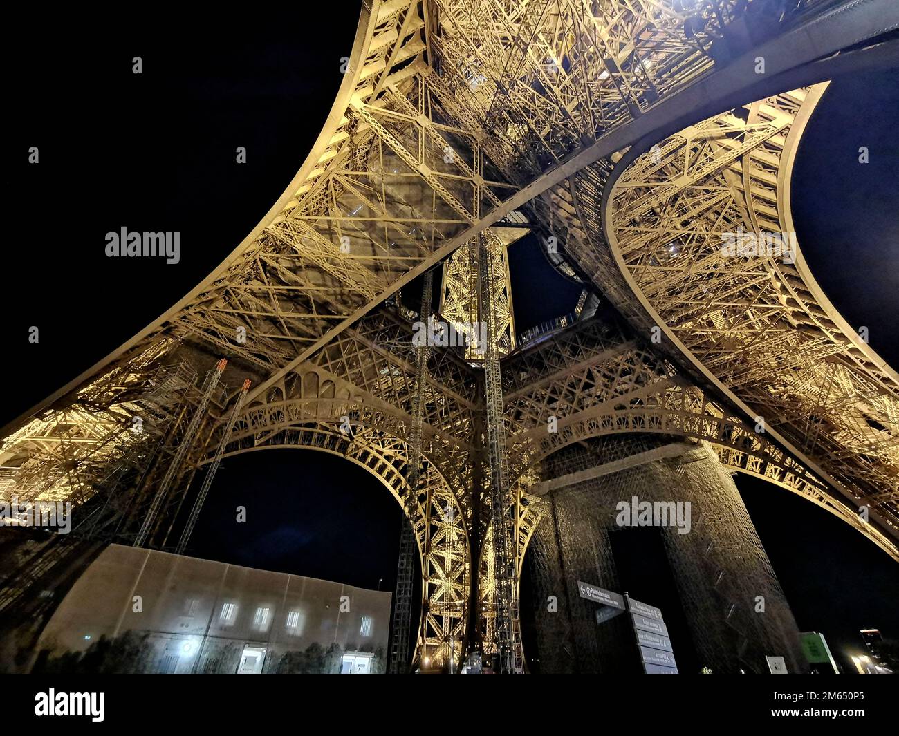 France, Paris, Perspective view from down of the Eiffel Tower at night ...