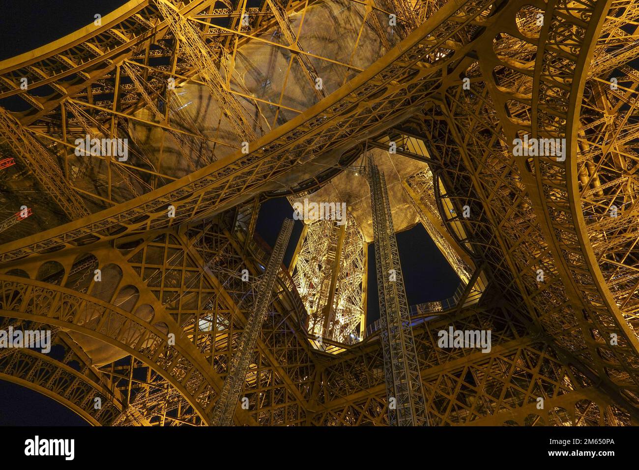 France, Paris, Perspective view from down of the Eiffel Tower at night ...