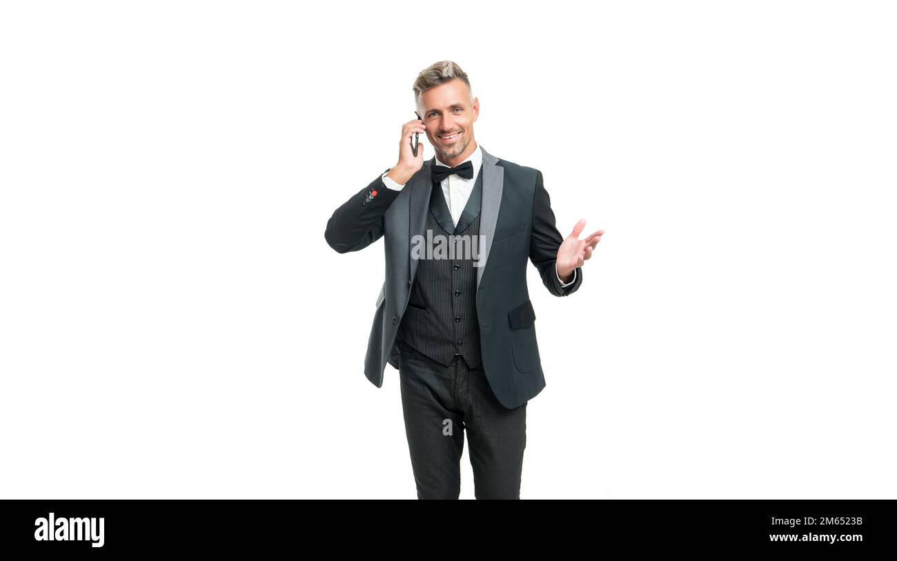 happy gentleman in tuxedo speak on phone isolated on white background ...