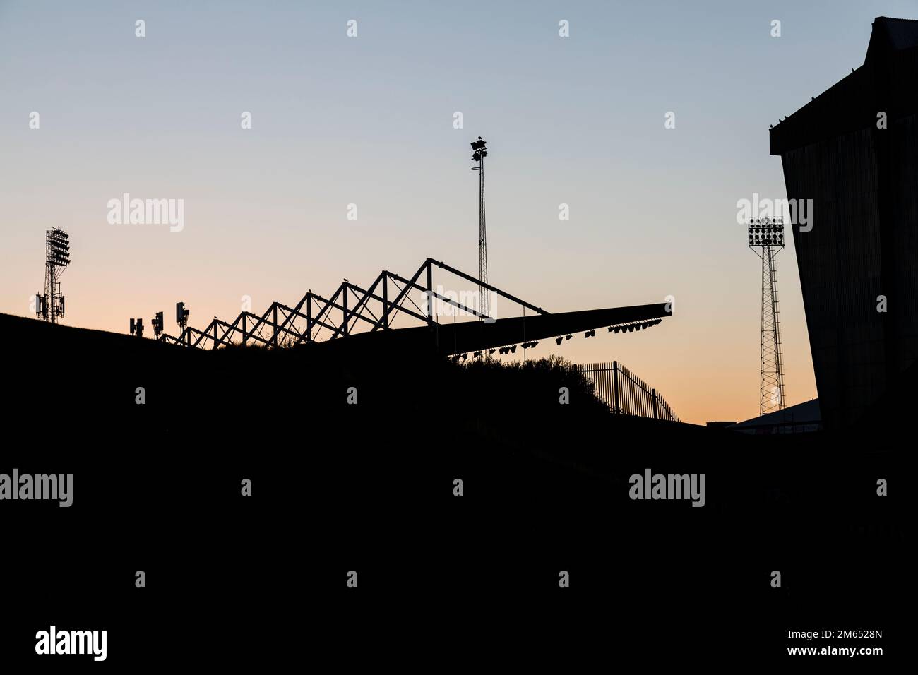Silhouette at sunset of Pittodrie the home of Aberdeen Football Club ...