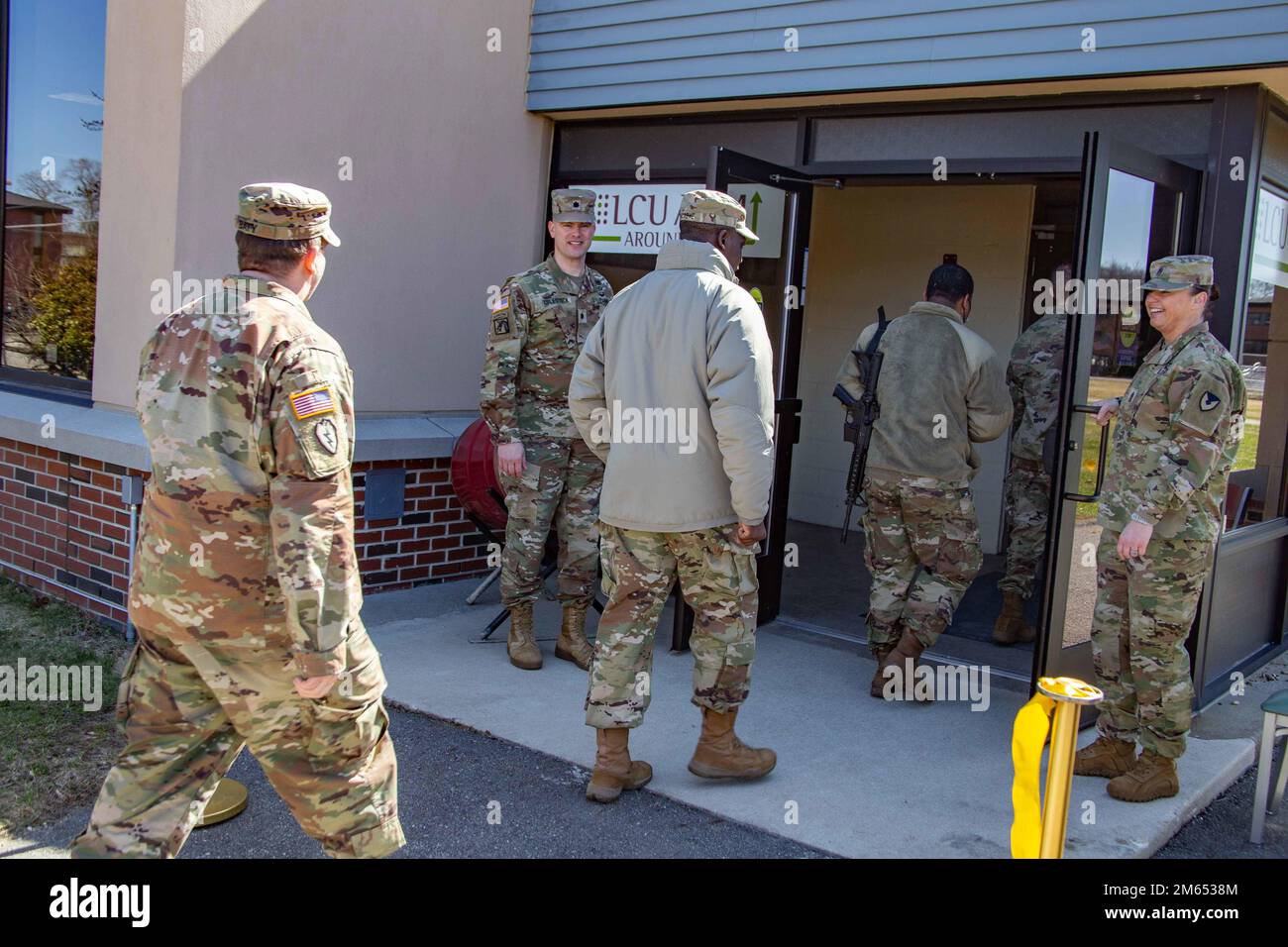 LTC Colestock and CSM Rogers hold open the doors to the dining facility ...