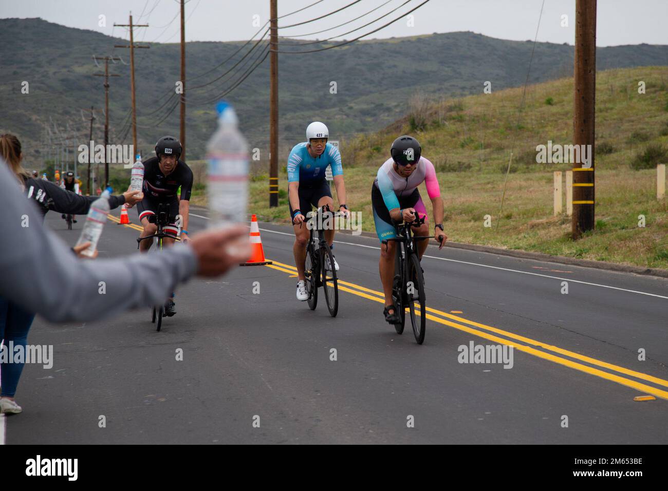 Volunteers hand out refreshments to participants of the Oceanside ...