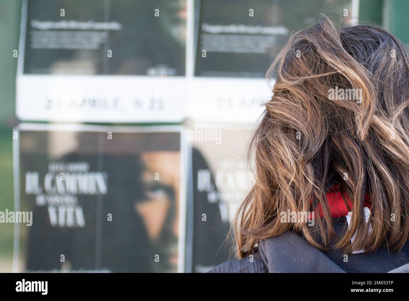 woman looking at cinema posters Stock Photo - Alamy