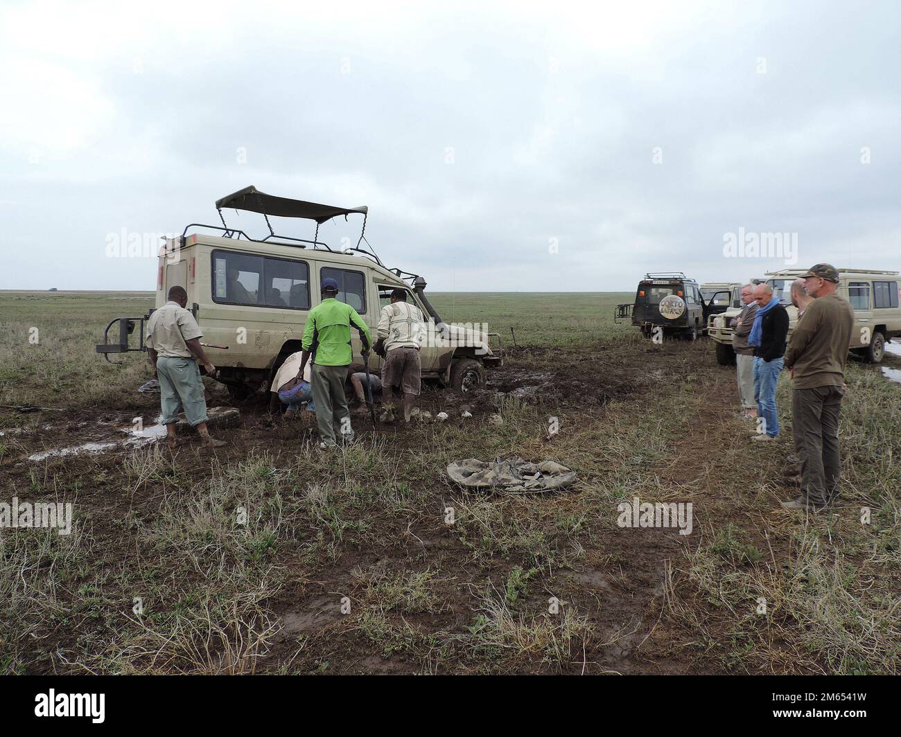 Guides and locals clearing an off-road safari car bogged down in the ...
