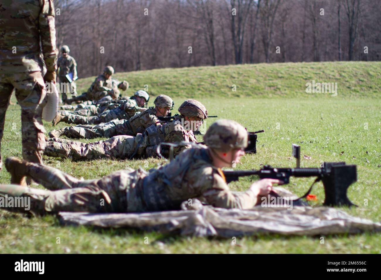 Soldiers lay in the supported prone position to zero their M4 carbine ...