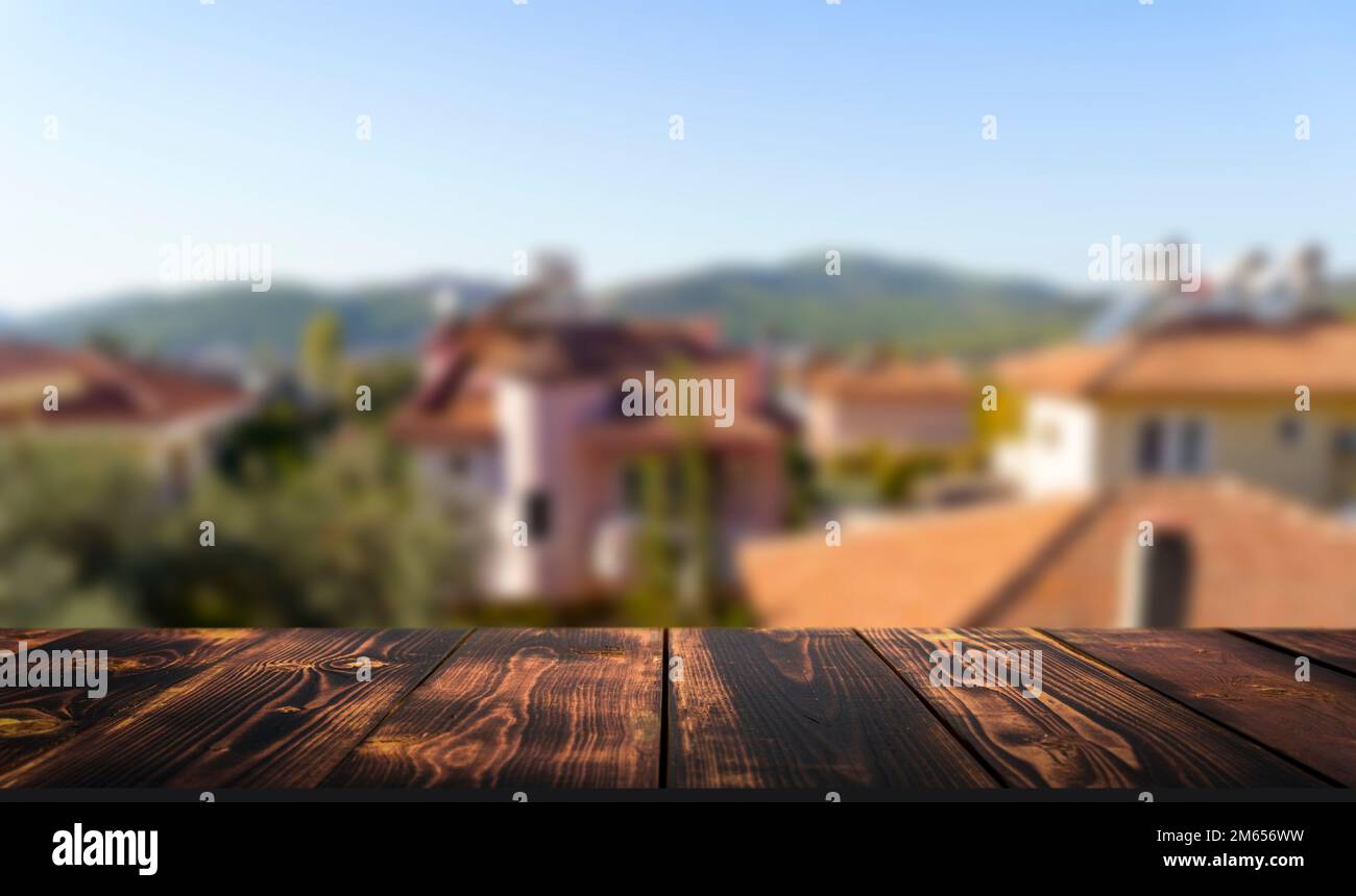 Wooden table background with landscape of mountains, green hills and ...
