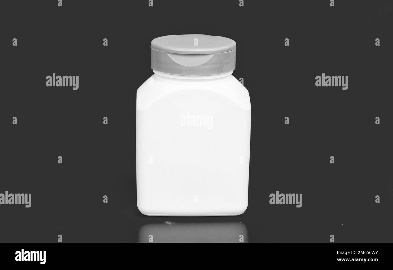 food supplement. presenting vitamin product. white unbranded pill jar ...