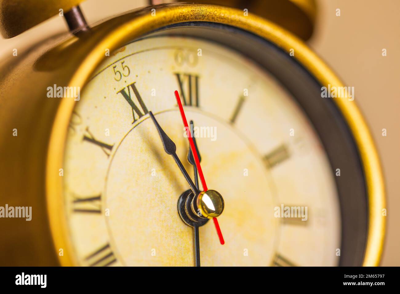 Retro alarm clock with five minutes to twelve o'clock. Old style ...