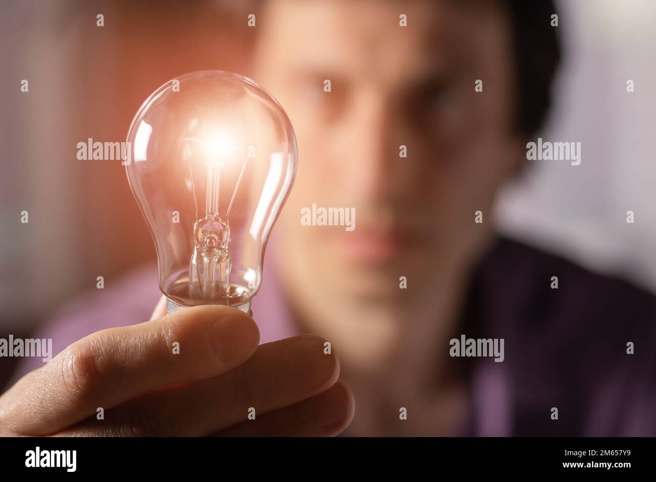Man holding light bulb in hand. idea concept with innovation and ...