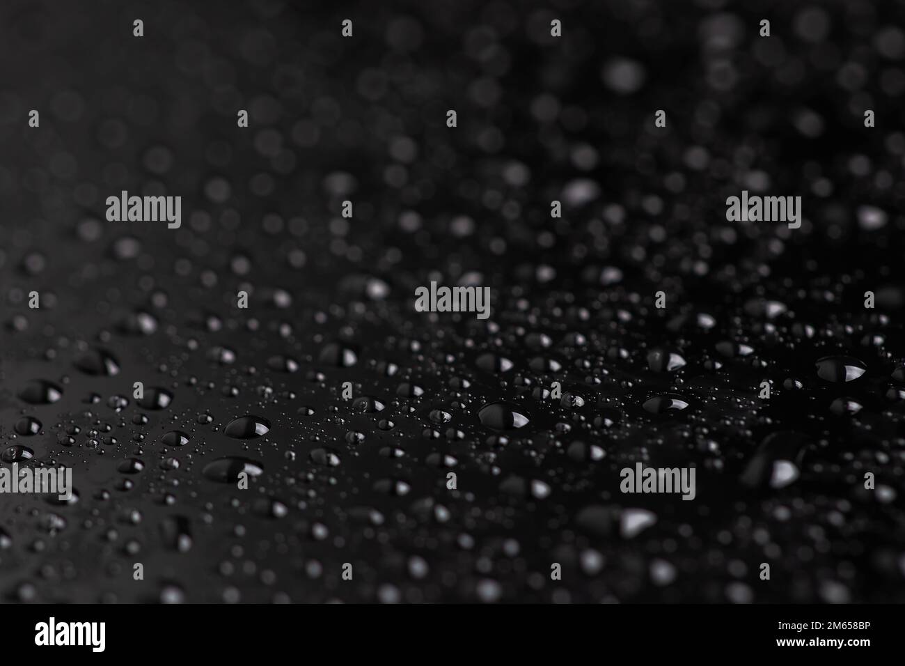 Water drops on the surface covered with foil. Surface tension Stock ...