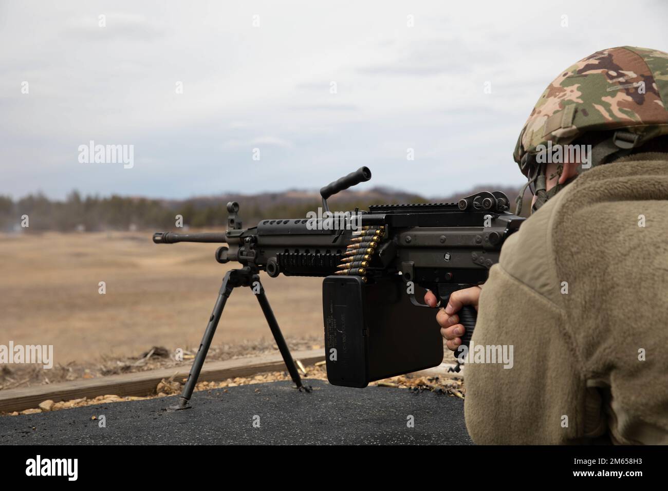 An Army Reserve Soldier fires a M249 light machine gun on the range at ...