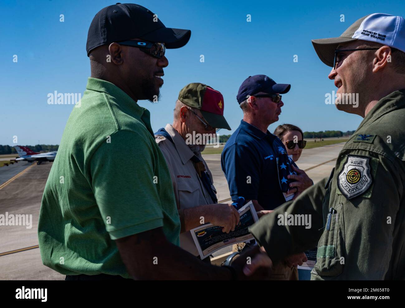 A Hometown Heroes receives a flag flown by the 77th Fighter Squadron ...