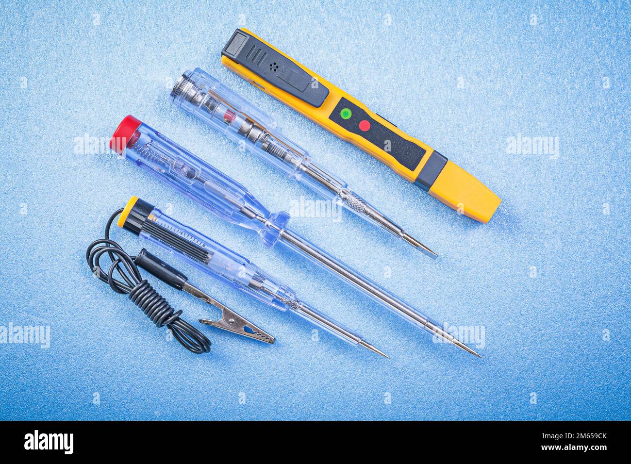 Assortment of electrical testers on blue background electricity concept ...
