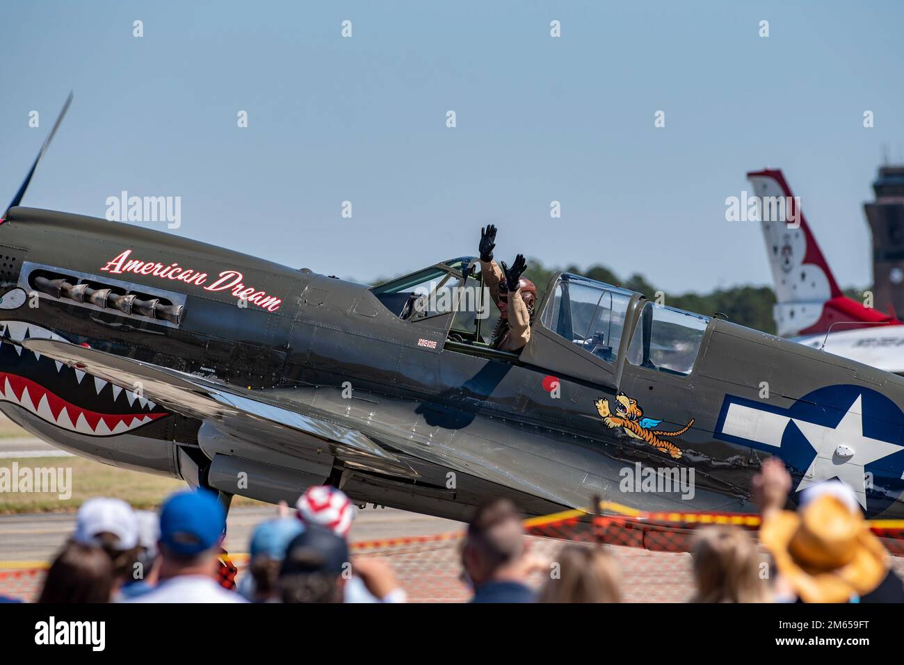 Thom Richard, an air demonstration pilot for the P-40, waves to a crowd ...