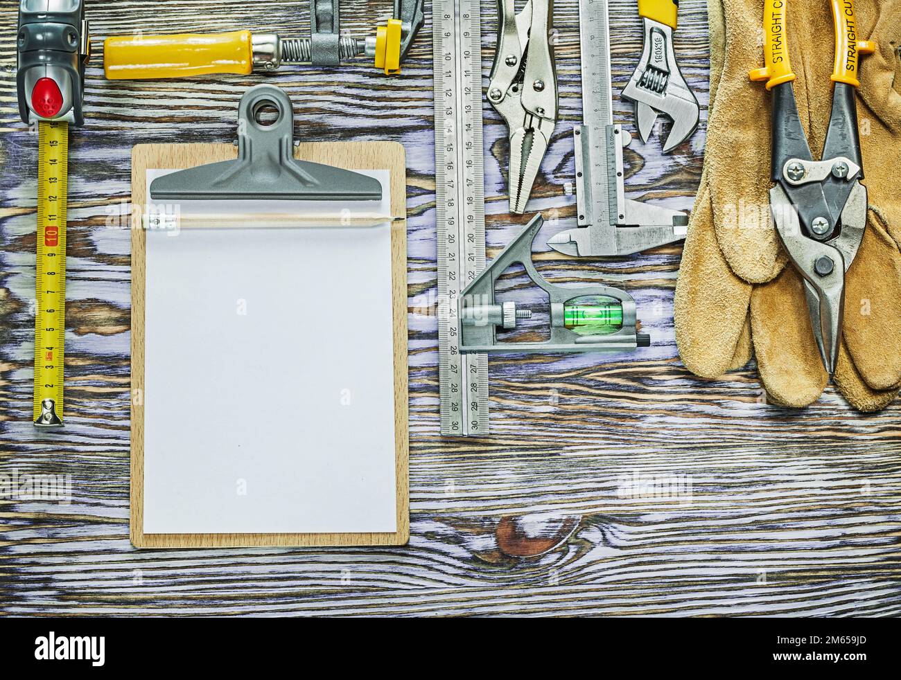 Clipboard construction tools on wooden board top view Stock Photo - Alamy