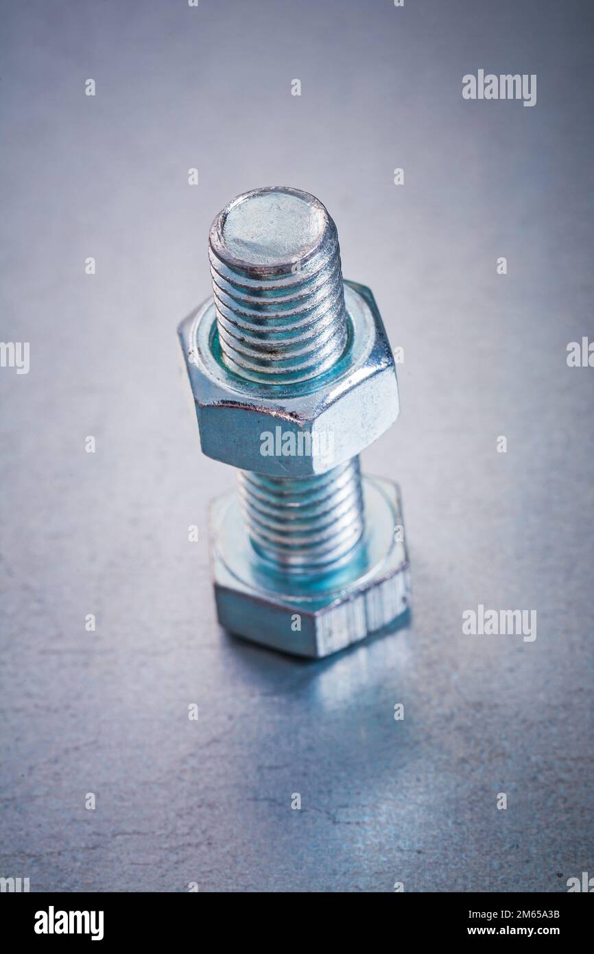 Metallic background with threaded bolt and construction nut repairing ...