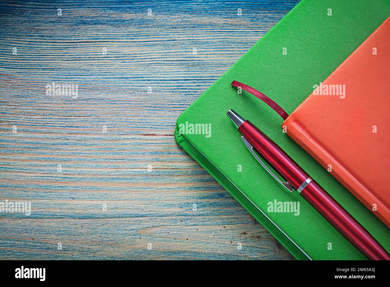 Note books biro pen on wooden board education concept Stock Photo - Alamy